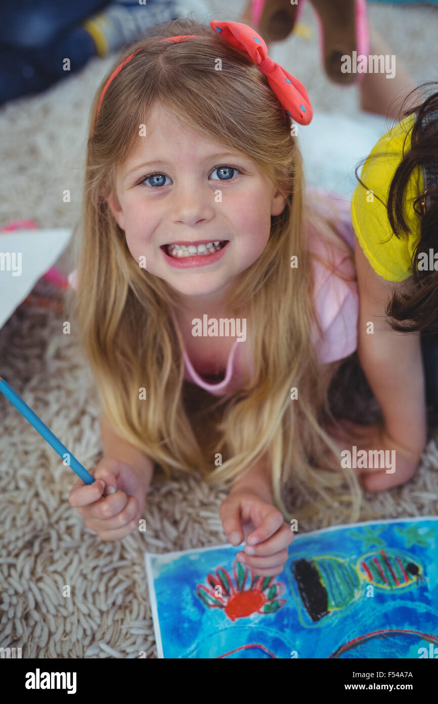 Smiling kid drawing pictures on paper Stock Photo - Alamy
