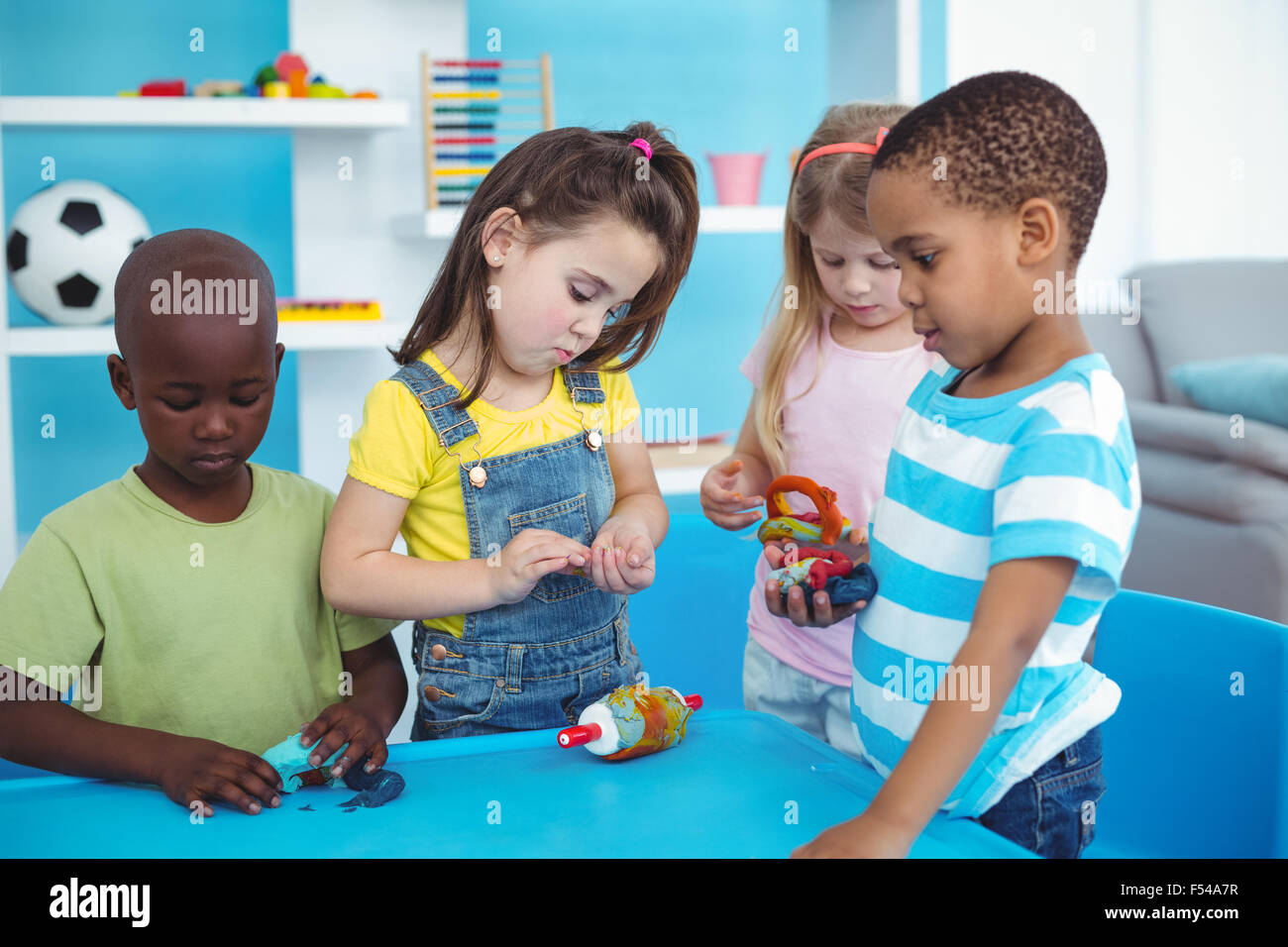 Happy kids enjoying arts and crafts together Stock Photo - Alamy