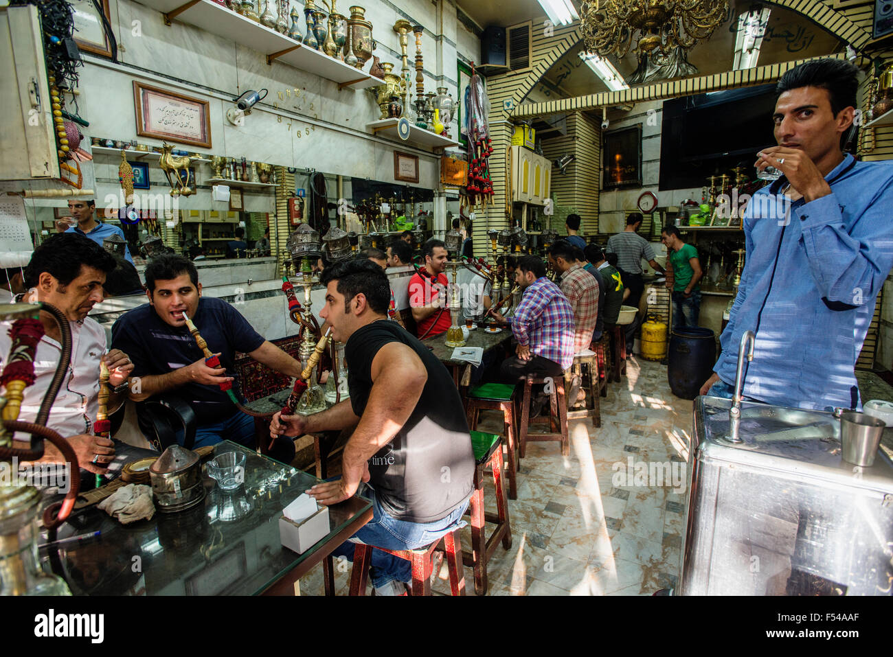 Men smoke qalyan and drink tea in coffeeshop, Tehran, Iran Stock Photo ...