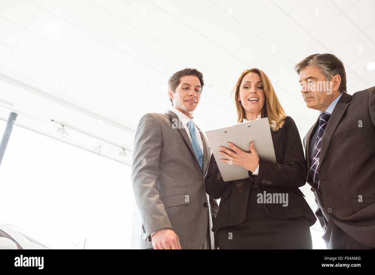 Group of smiling business team standing together Stock Photo - Alamy