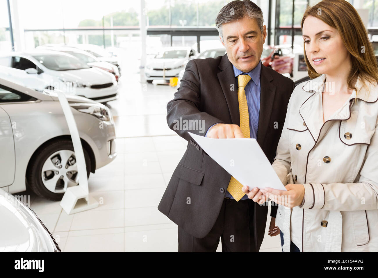 Salesman explaining the contract to a client Stock Photo - Alamy