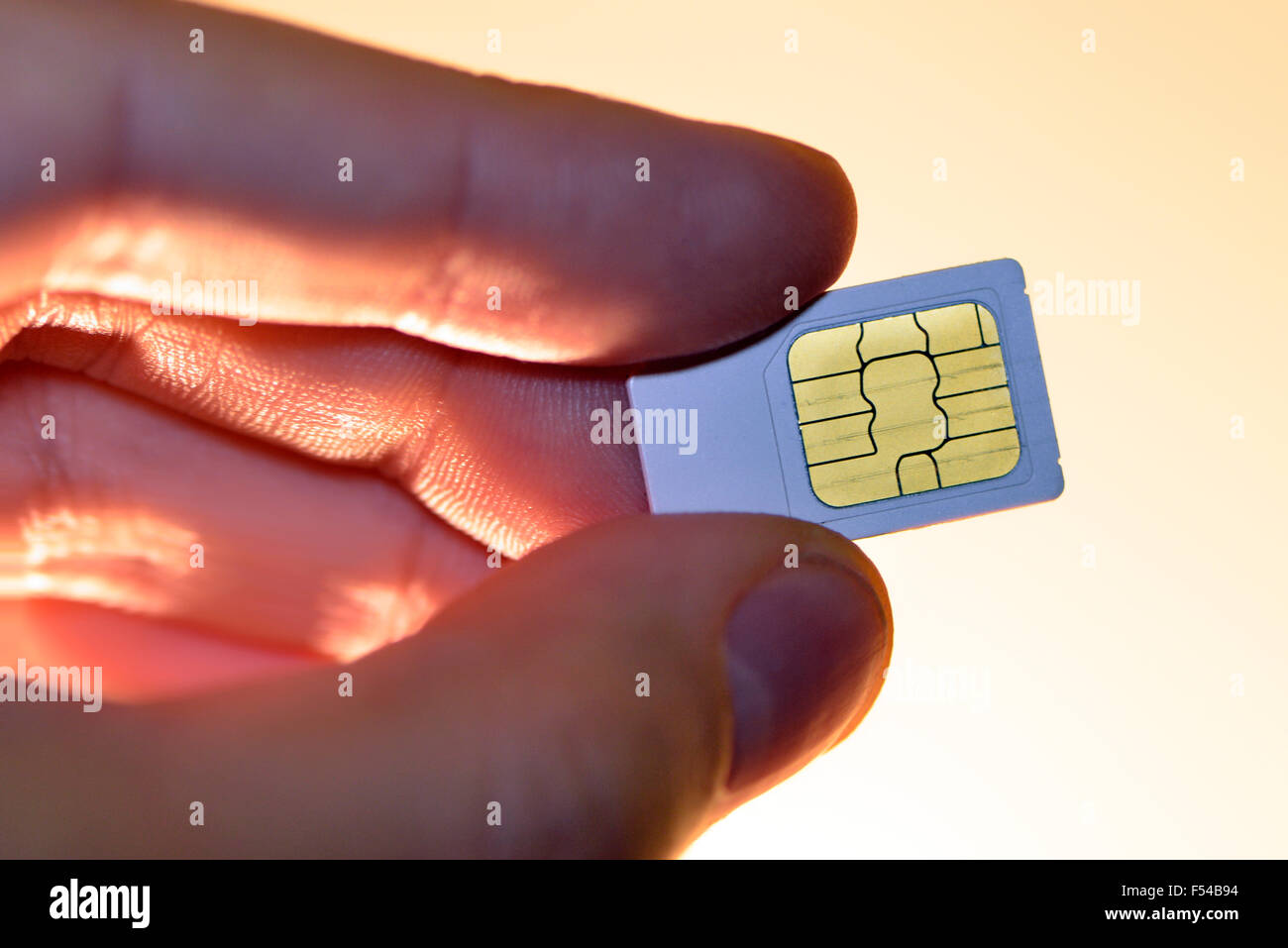 Mobile Phone SIM Card Held Between the Fingers of a man Stock Photo - Alamy