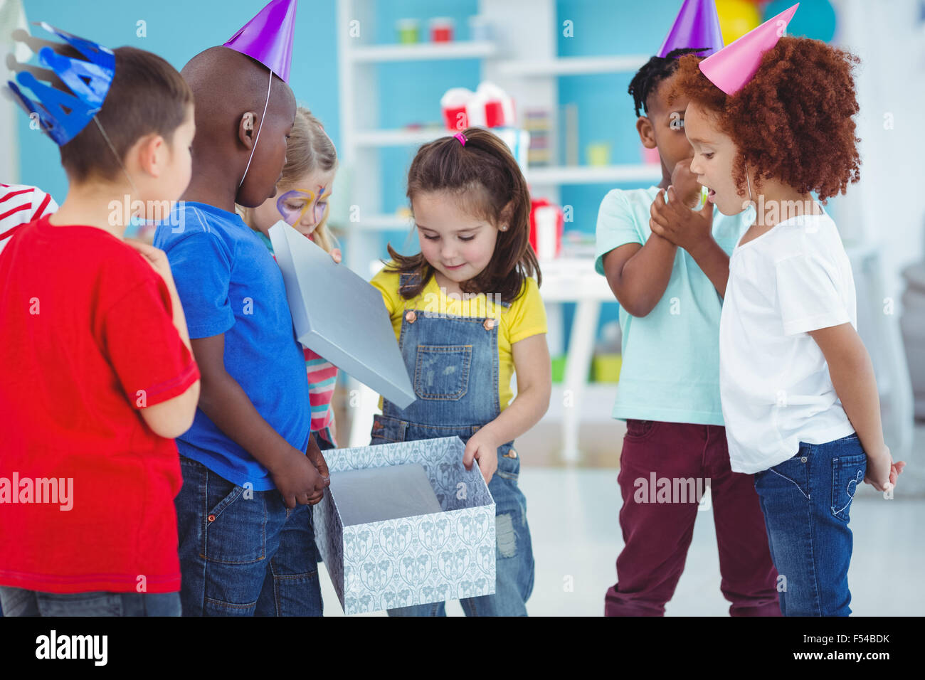 Happy girl opening a present Stock Photo - Alamy