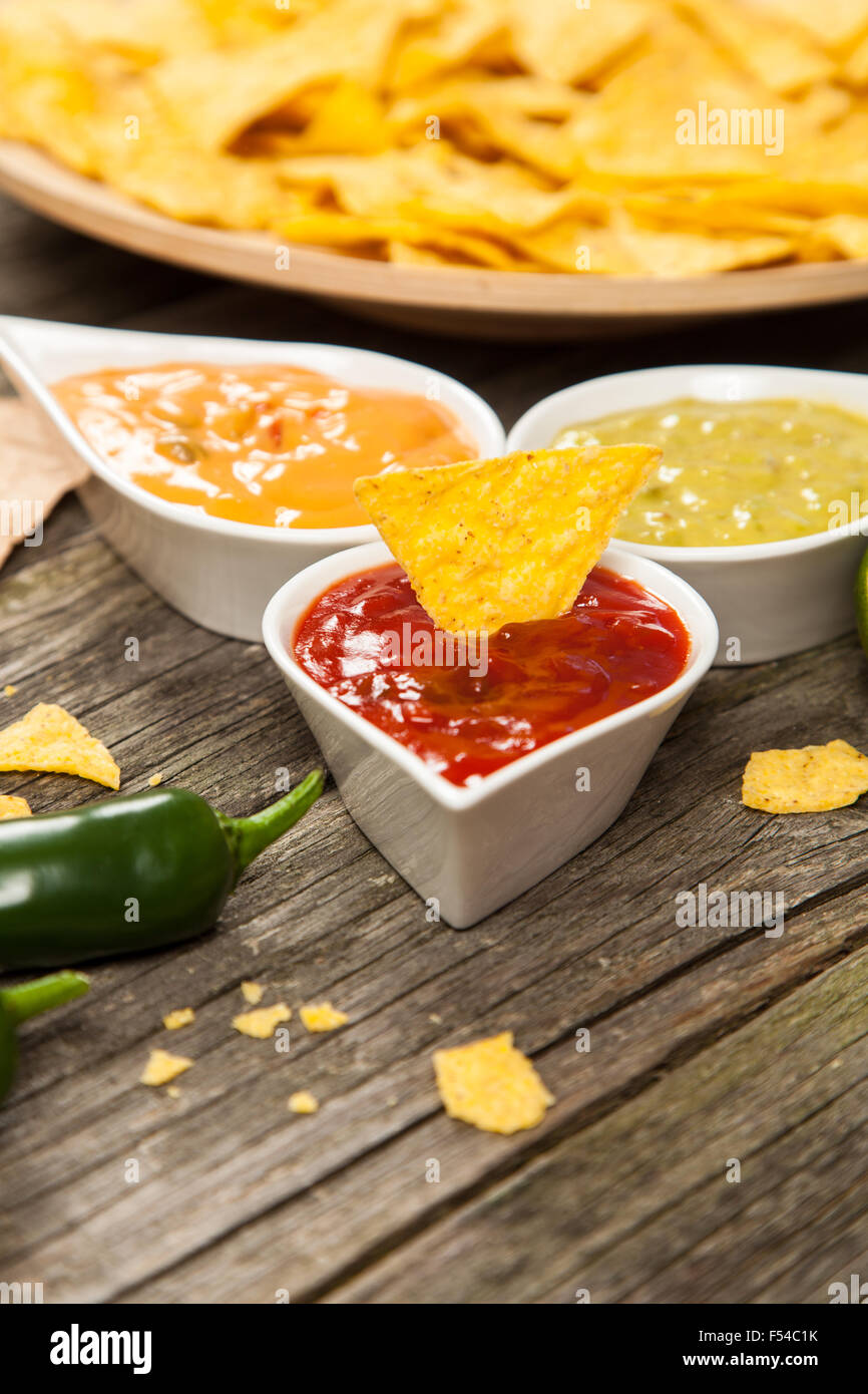 Plate of nachos with different dips Stock Photo - Alamy