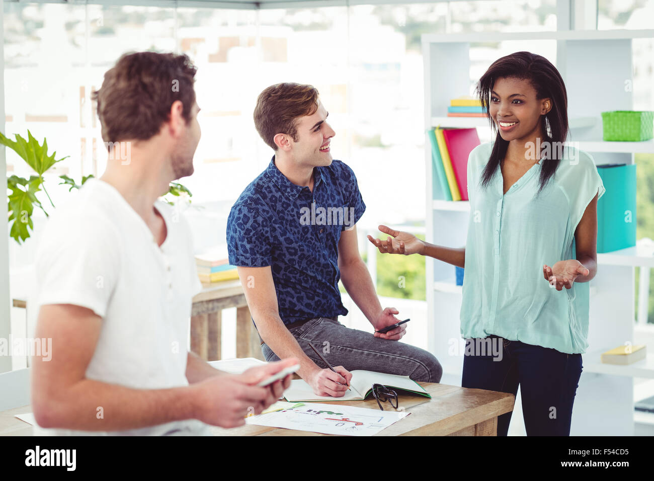 Smiling creative team working together Stock Photo - Alamy