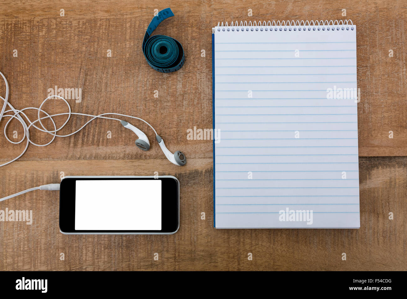 Notepad with smartphone and measuring tape Stock Photo - Alamy