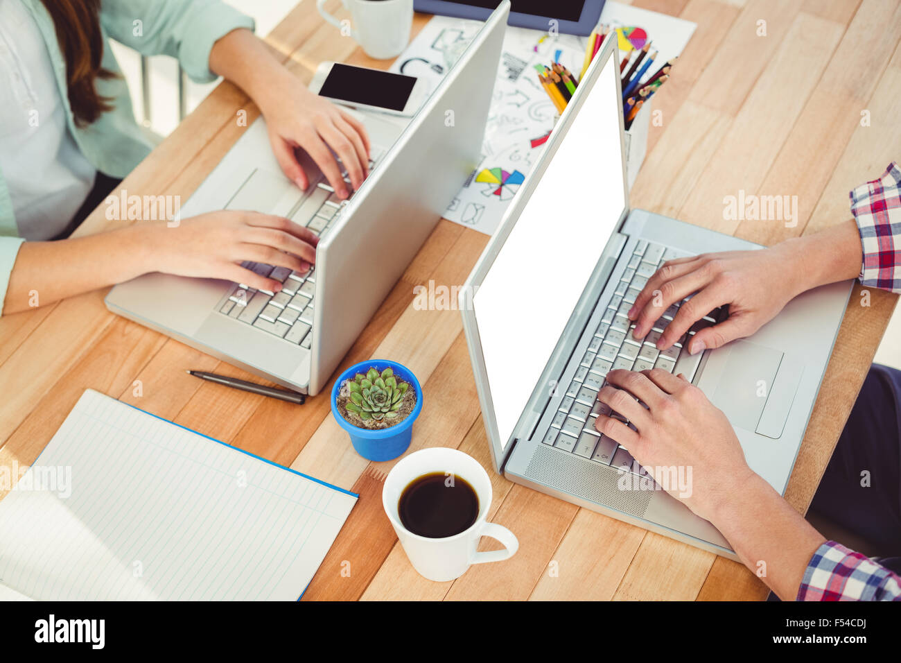 Creative team working together at desk Stock Photo - Alamy