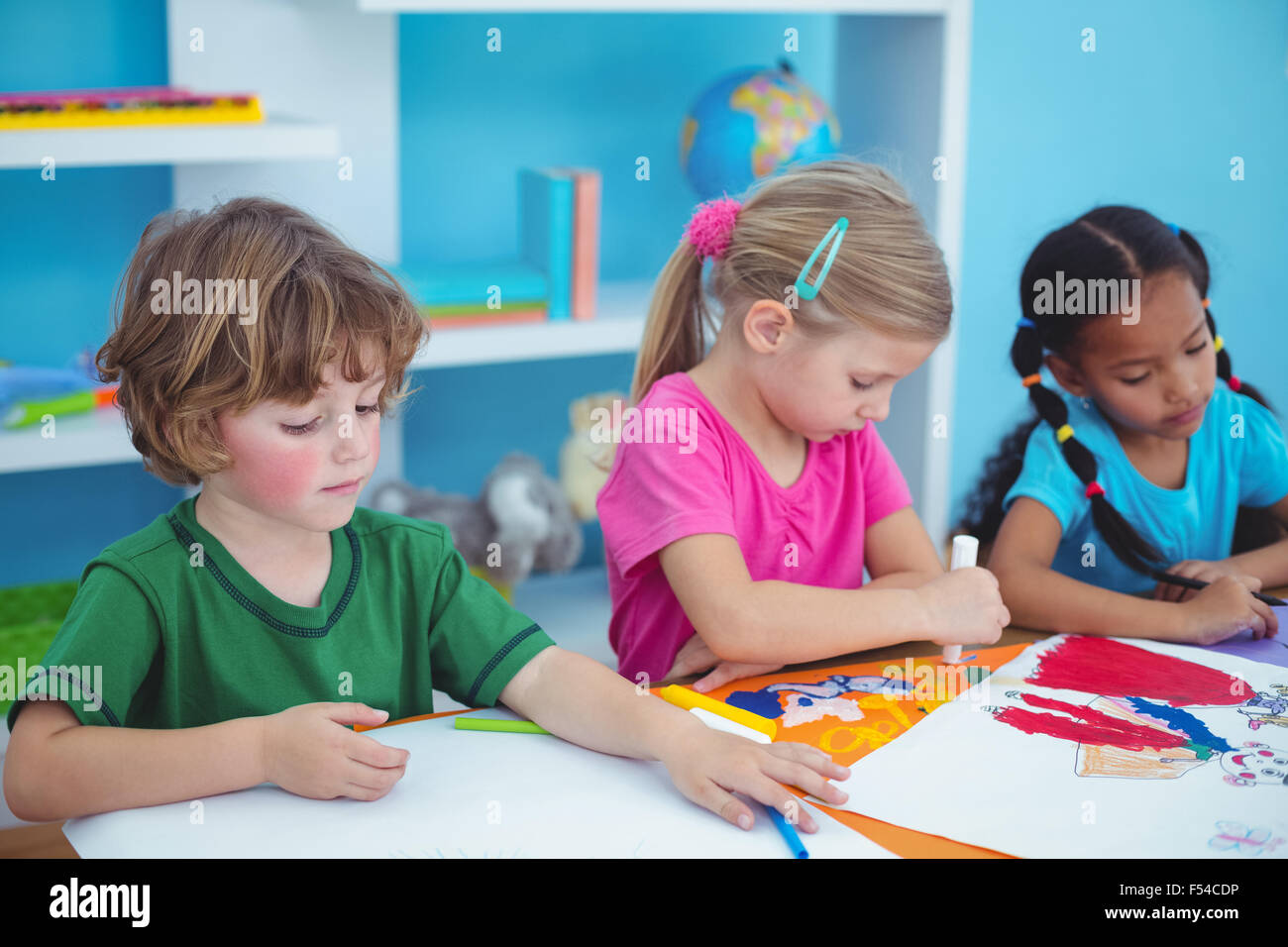 Happy kids all drawing pictures Stock Photo - Alamy