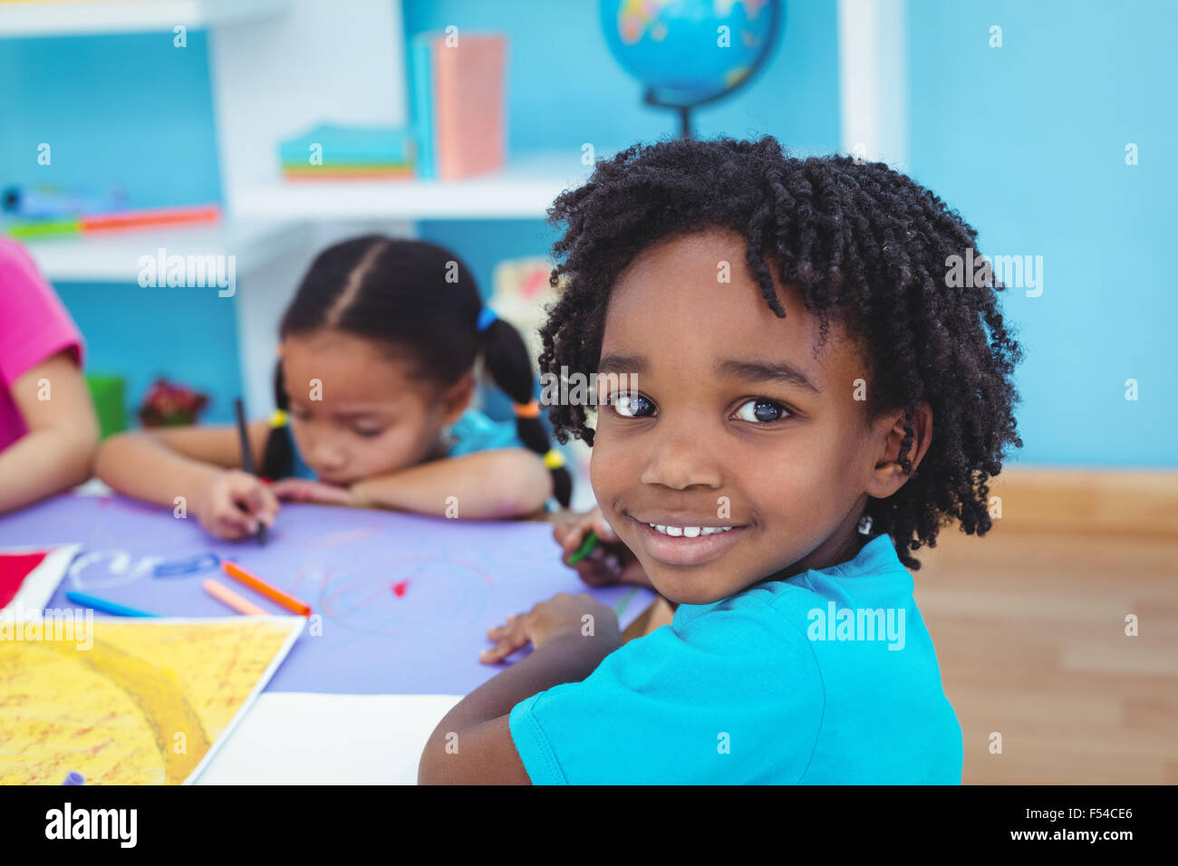 Children drawing on coloured paper Stock Photo - Alamy