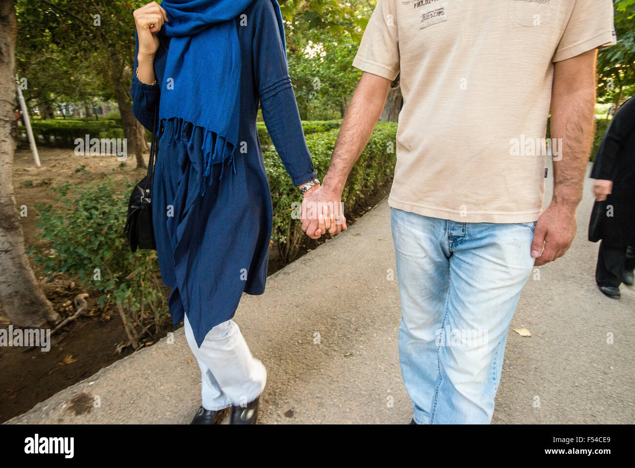 Couple holding hands in Park-e Laleh in Tehran, Iran Stock Photo - Alamy