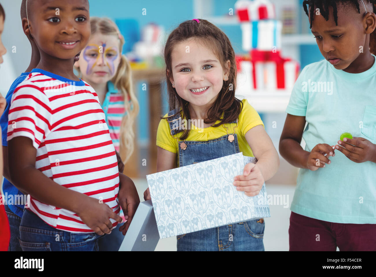 Happy girl opening a present Stock Photo - Alamy