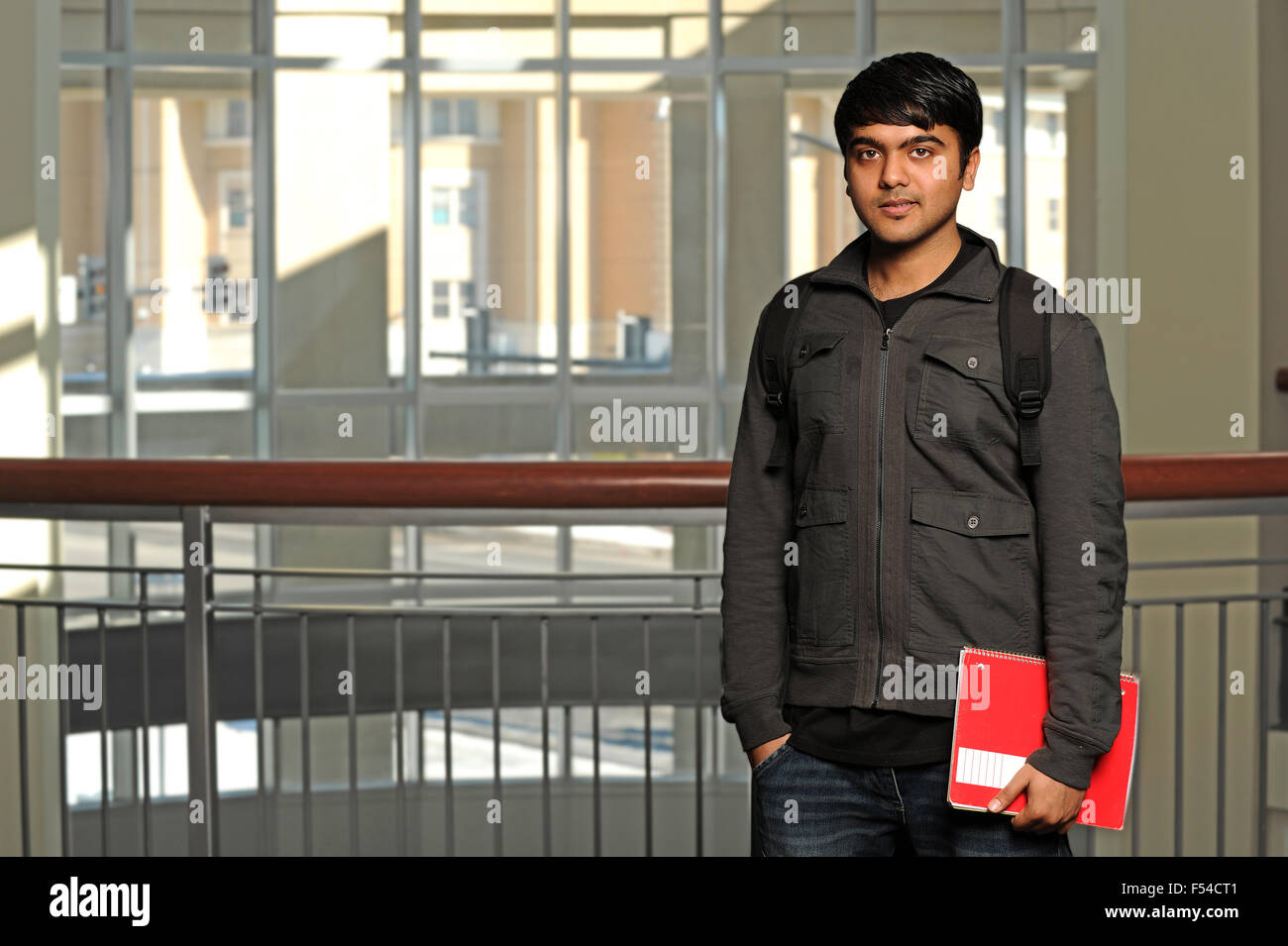 Young Indian student holding notebook inside school building Stock ...