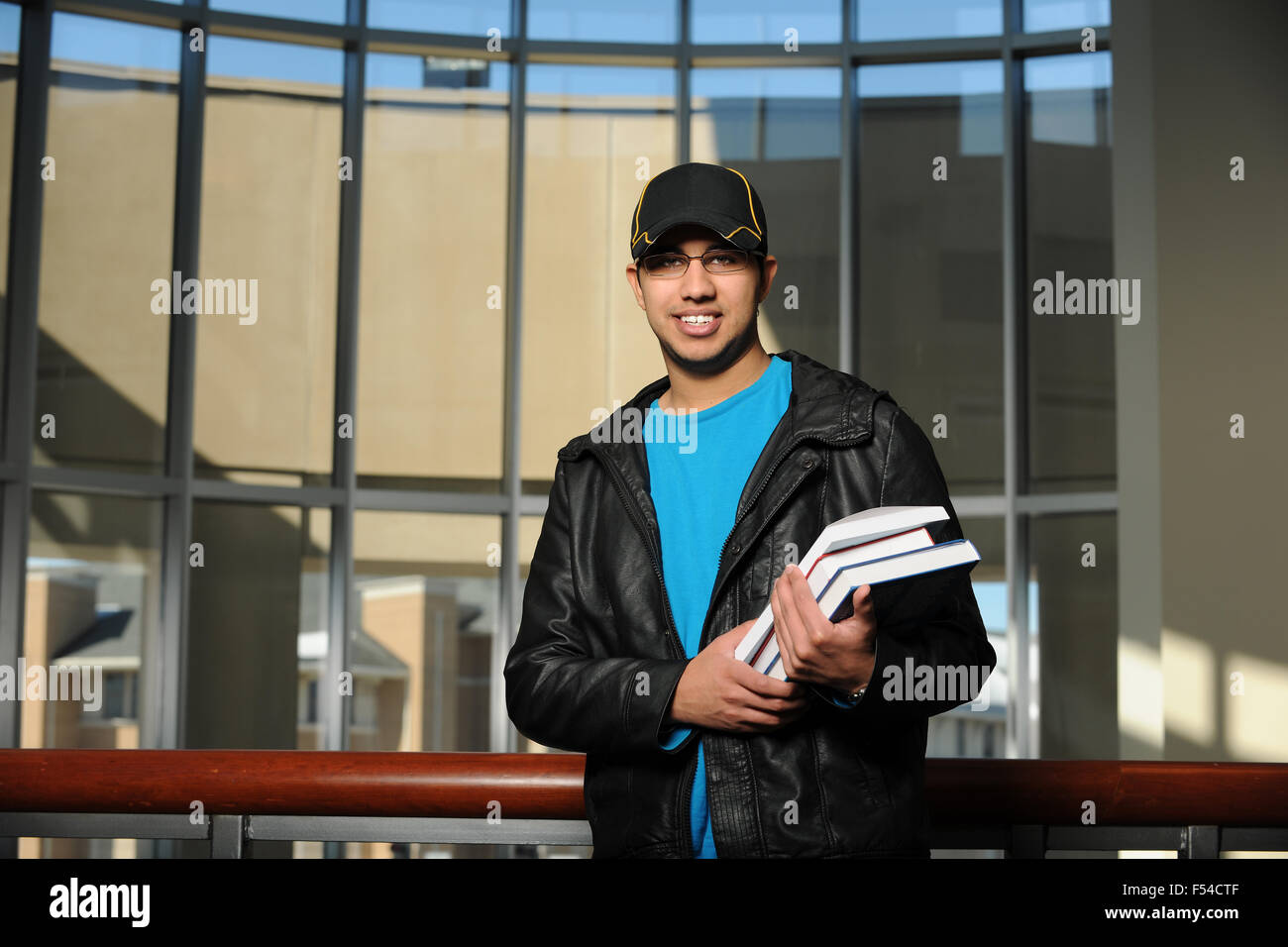 Portrait of ethnic college student inside building Stock Photo - Alamy