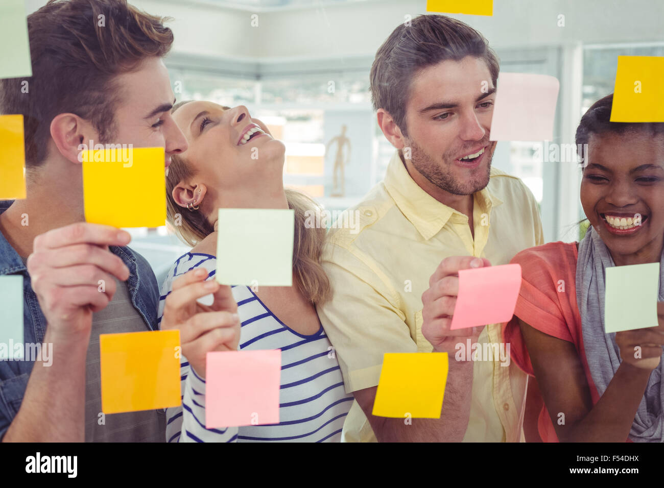 Creative team using post it notes Stock Photo - Alamy