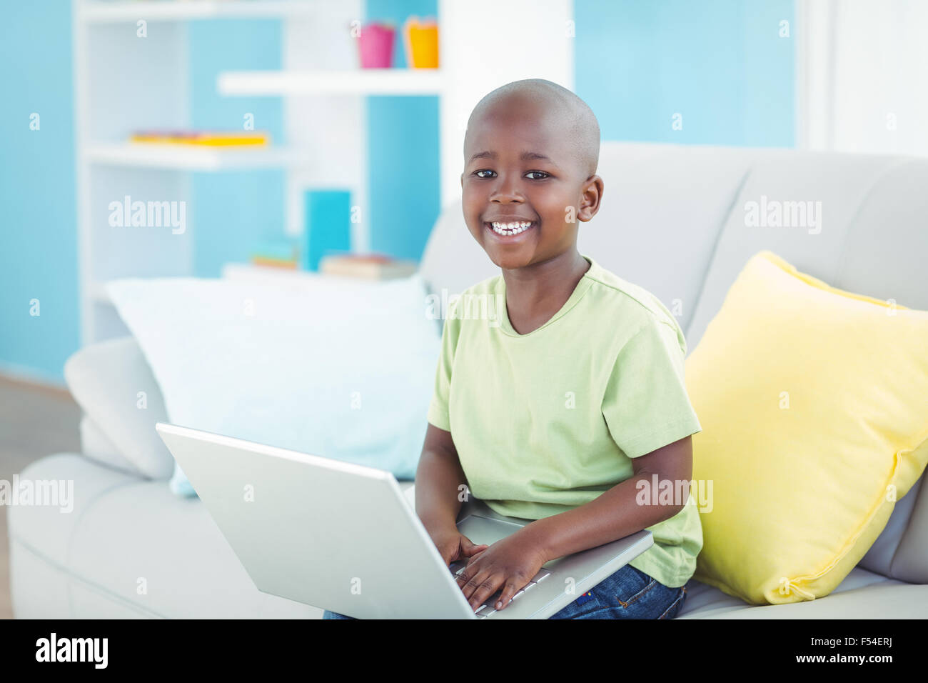 Happy boy using a laptop Stock Photo - Alamy