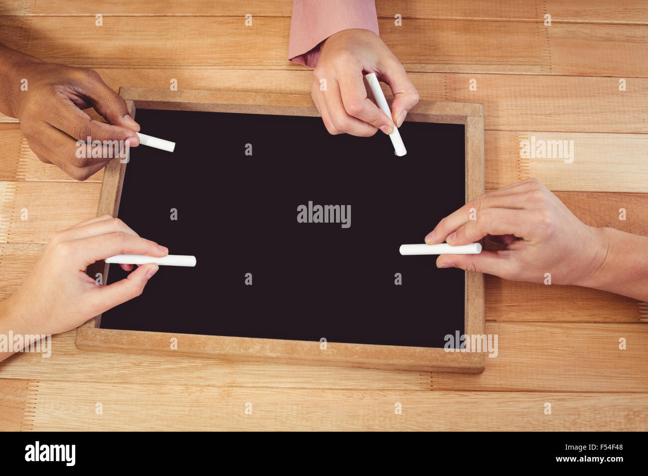 Young creative team using chalkboard Stock Photo - Alamy