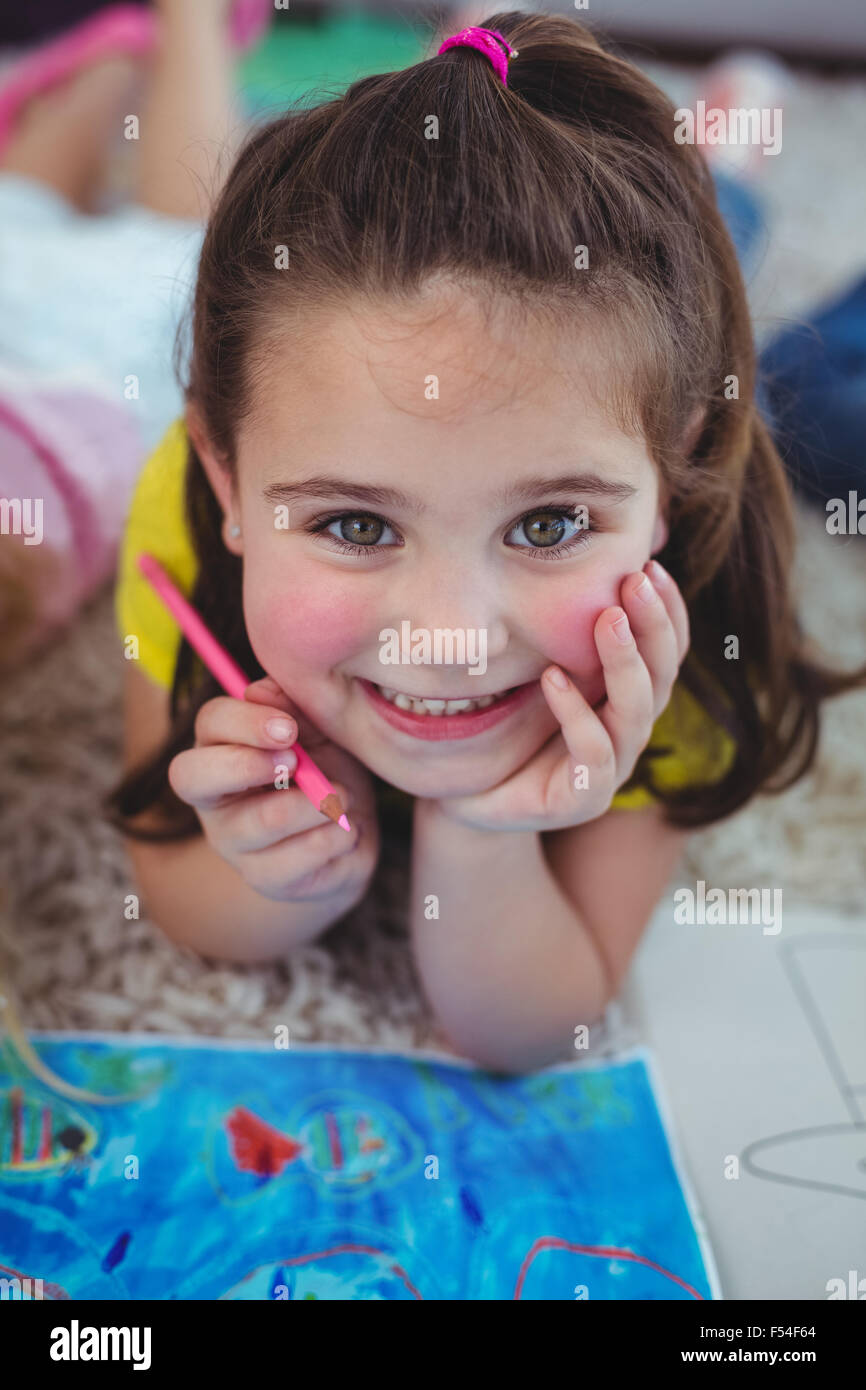 Smiling kid drawing pictures on paper Stock Photo - Alamy
