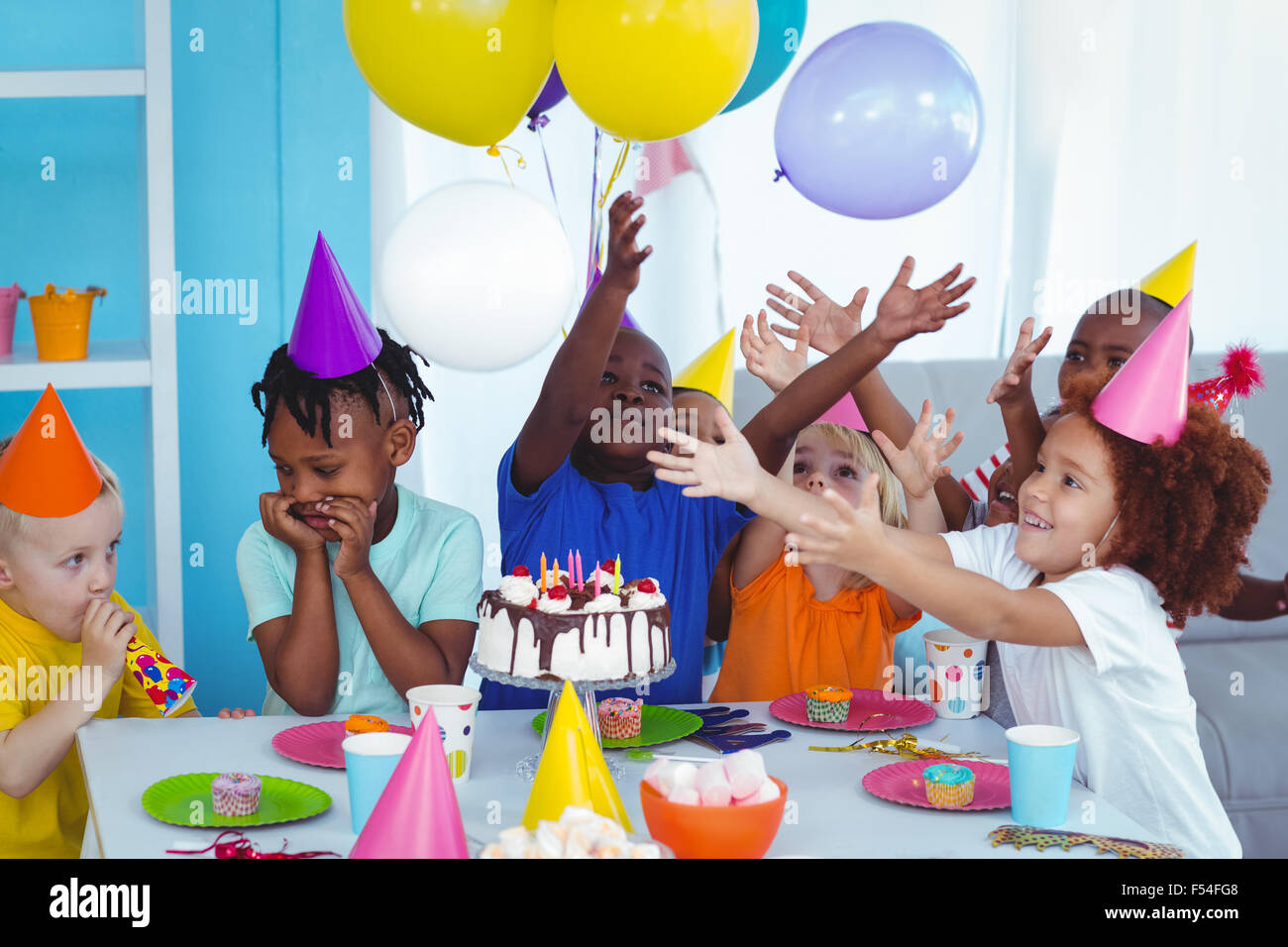 Excited kids enjoying a birthday party Stock Photo - Alamy