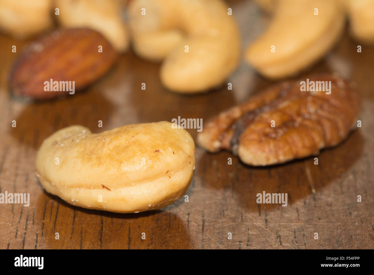 Assorted nuts on dark wooden table Stock Photo - Alamy