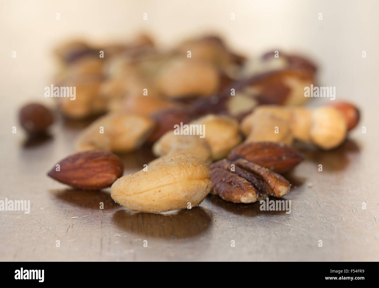 Mixed nuts on a rustic wooden table Stock Photo - Alamy