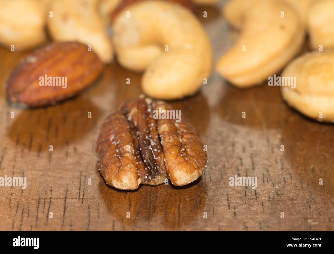 Mixed nuts on dark wood table Stock Photo - Alamy