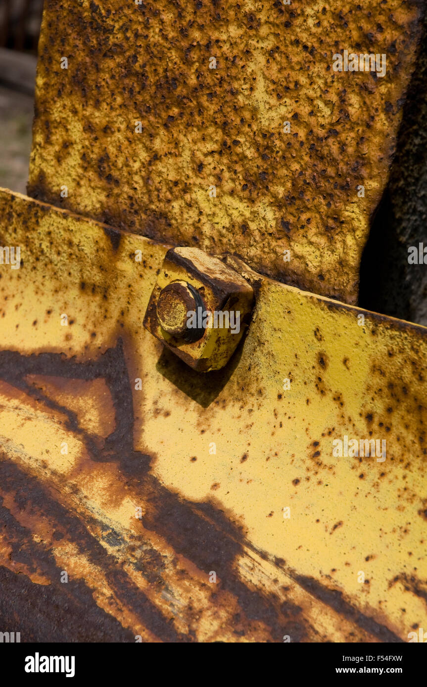 Yellow rusted metal railing with nut and bolt Stock Photo - Alamy