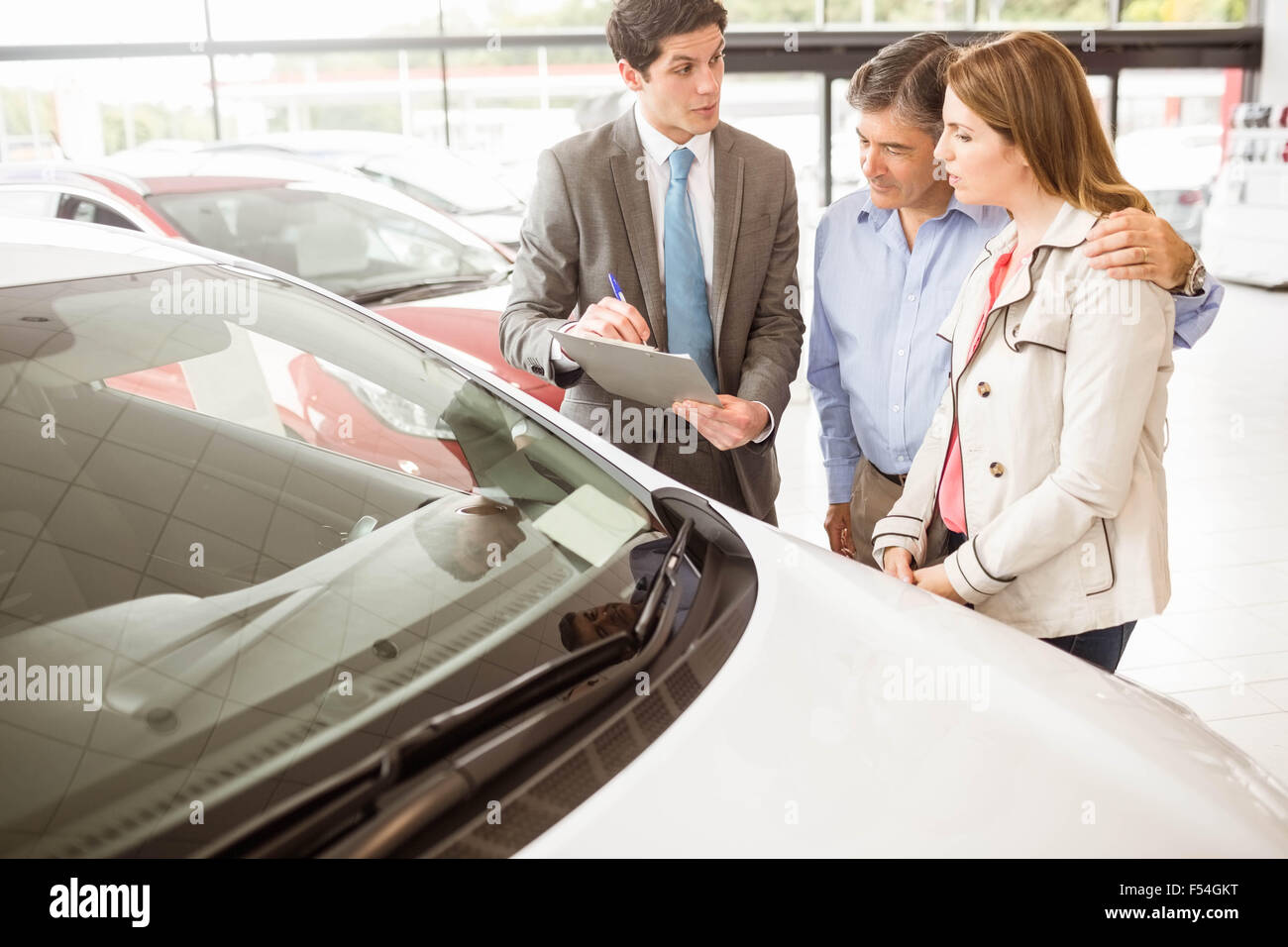 Smiling businessman presenting a car Stock Photo - Alamy
