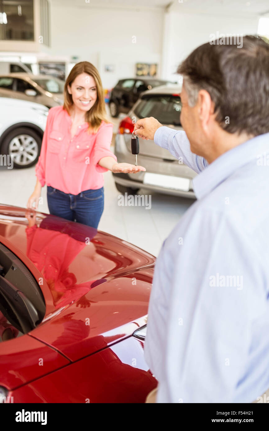 Smiling businessman giving car key to happy customer Stock Photo - Alamy