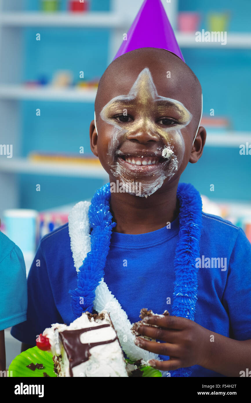 Happy kid eating birthday cake Stock Photo - Alamy