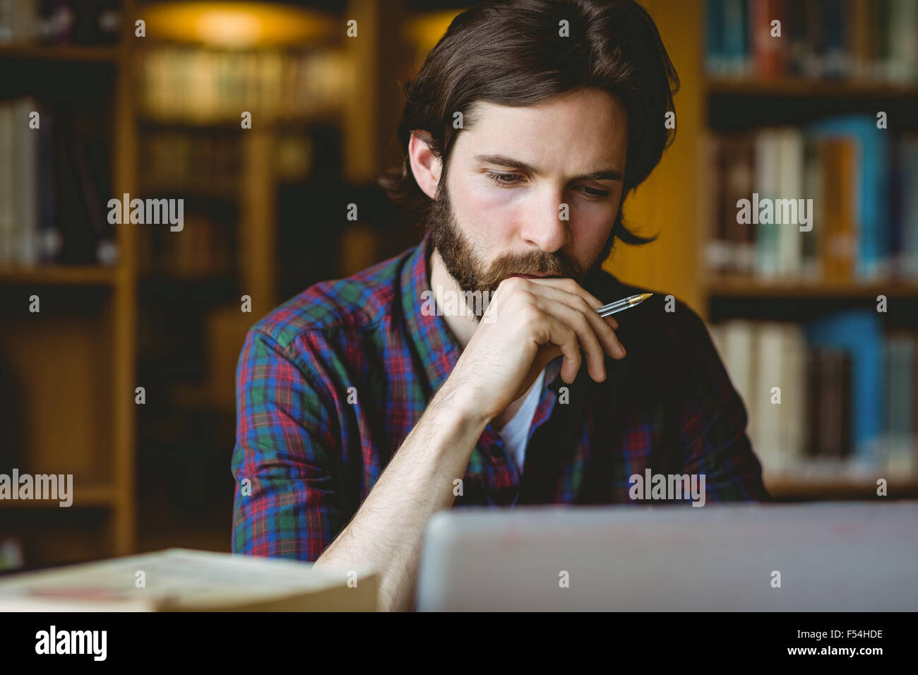 Thoughtful man laptop in library hi-res stock photography and images ...