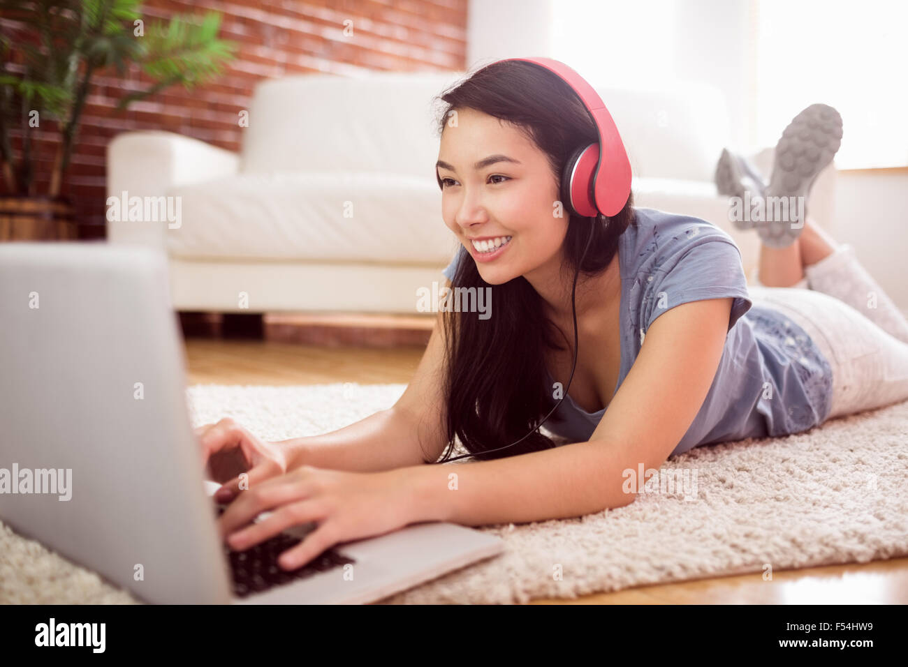 Asian woman using laptop on floor Stock Photo - Alamy