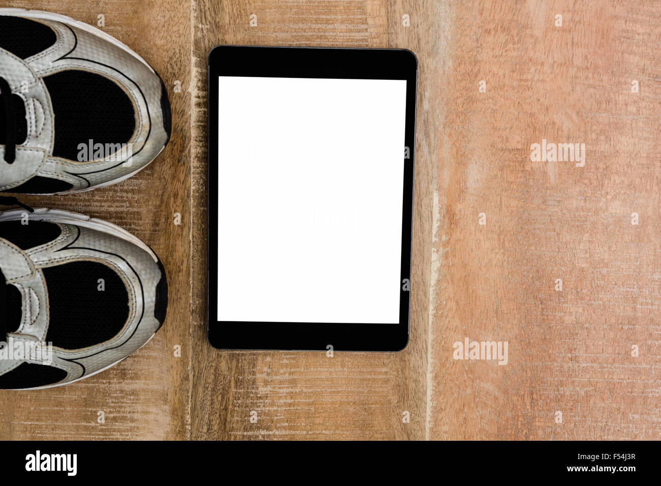 Tablet pc with running shoes Stock Photo - Alamy