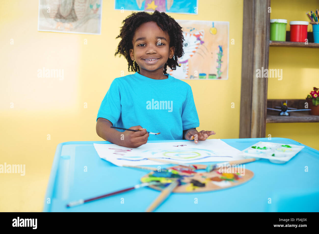Smiling child creating a picture Stock Photo - Alamy