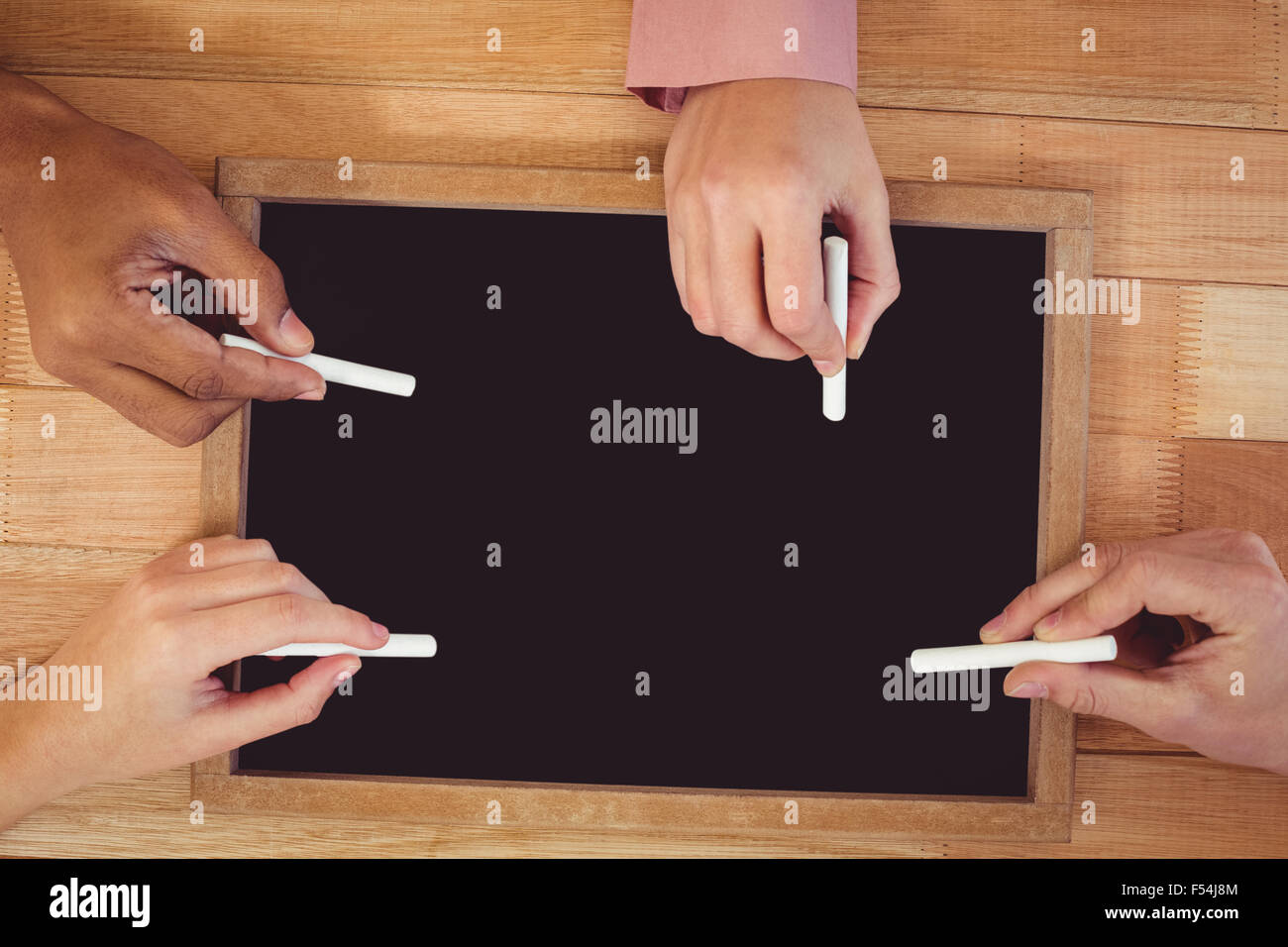 Young creative team using chalkboard Stock Photo - Alamy