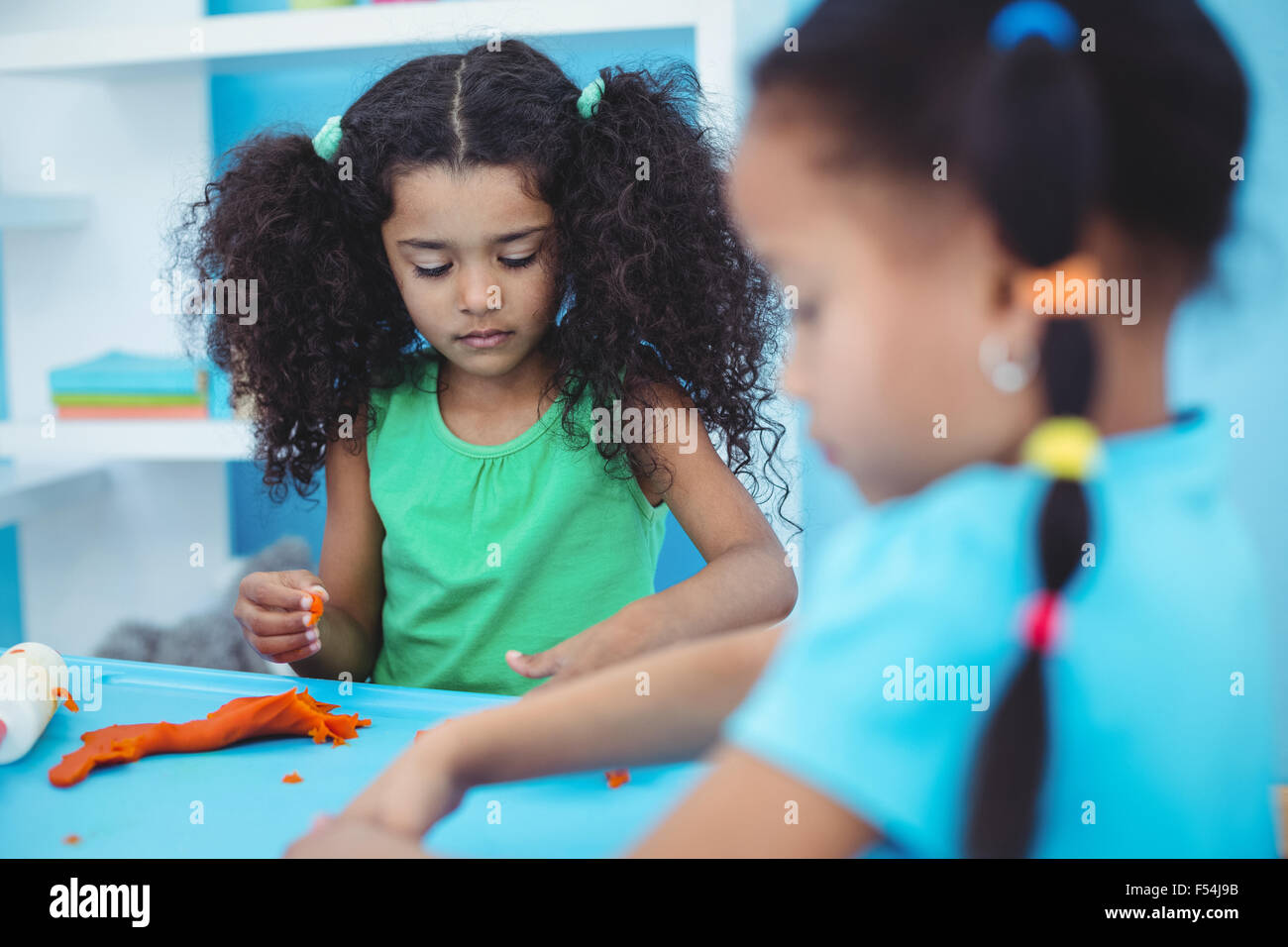 Smiling kids using modelling clay Stock Photo - Alamy