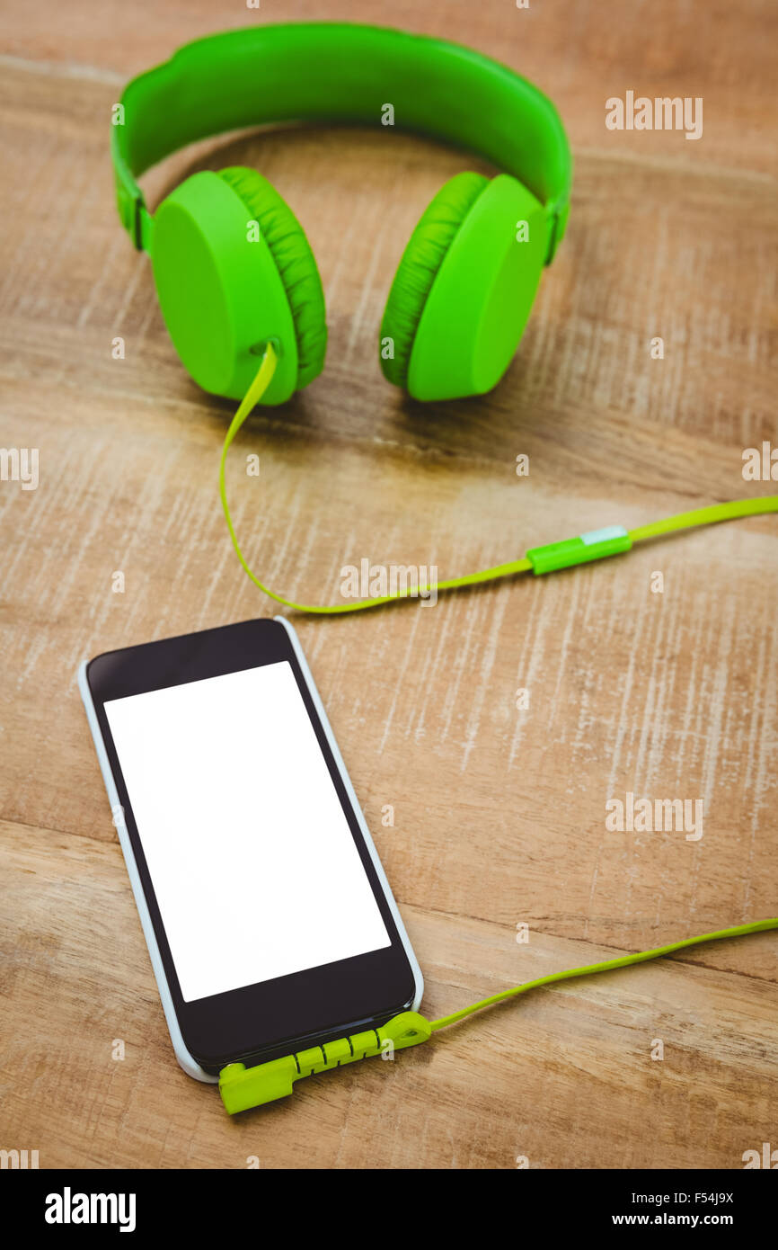 Green headphone with a back smartphone Stock Photo - Alamy