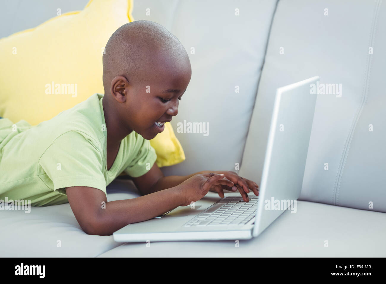 Happy boy using a laptop Stock Photo - Alamy