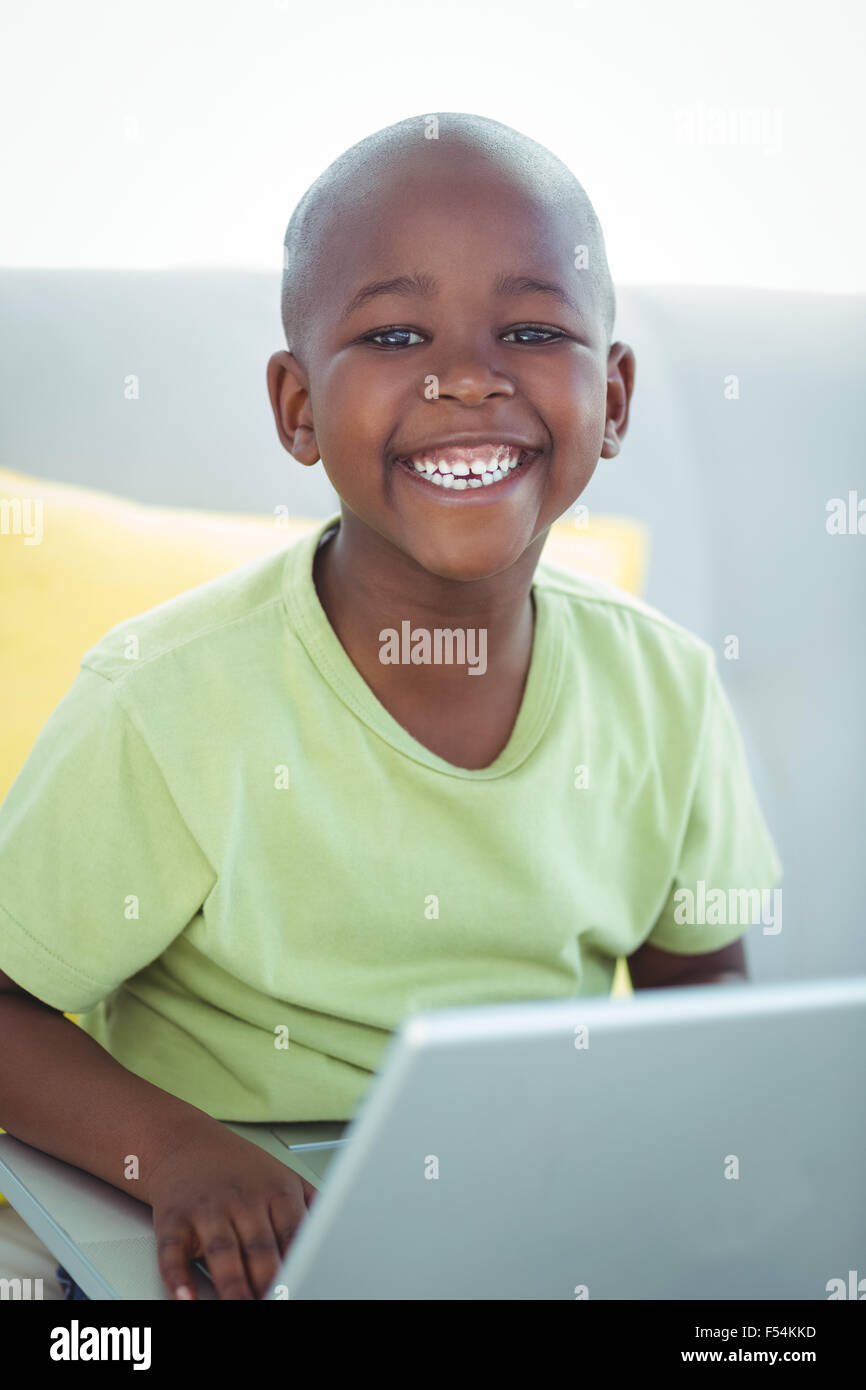 Happy boy using a laptop Stock Photo - Alamy