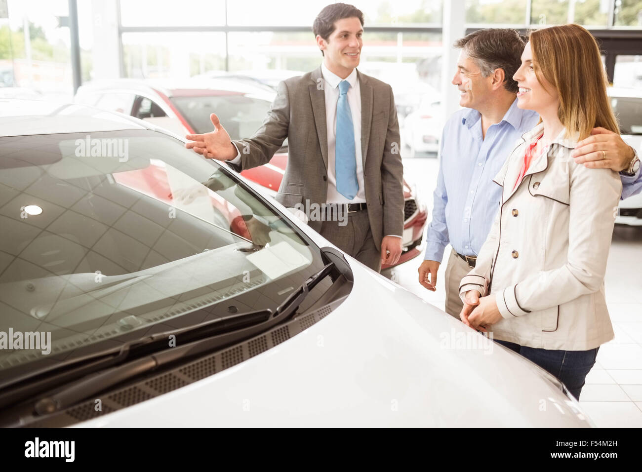 Smiling businessman presenting a car Stock Photo - Alamy
