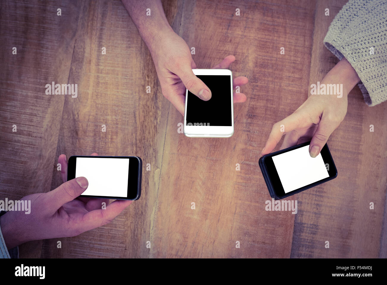Creative team all using smartphones Stock Photo - Alamy