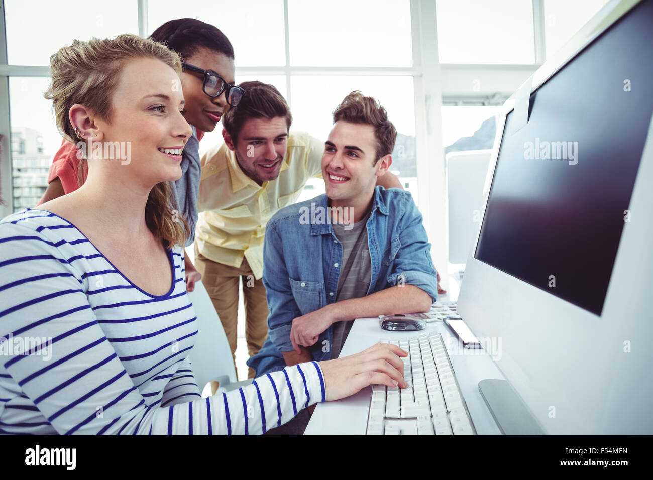 Creative business team working hard together on pc Stock Photo - Alamy