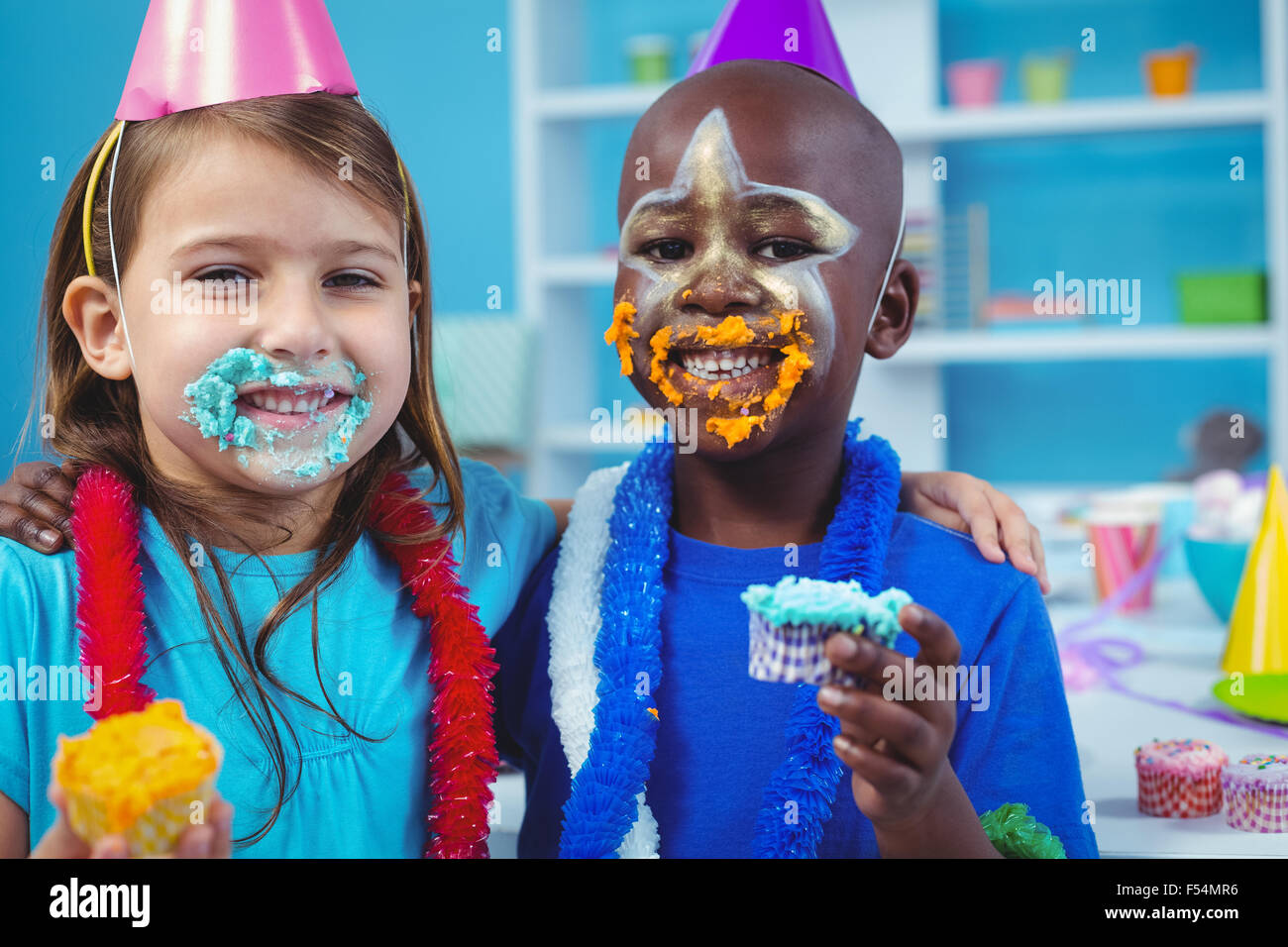 Smiling kids with icing on their faces Stock Photo - Alamy