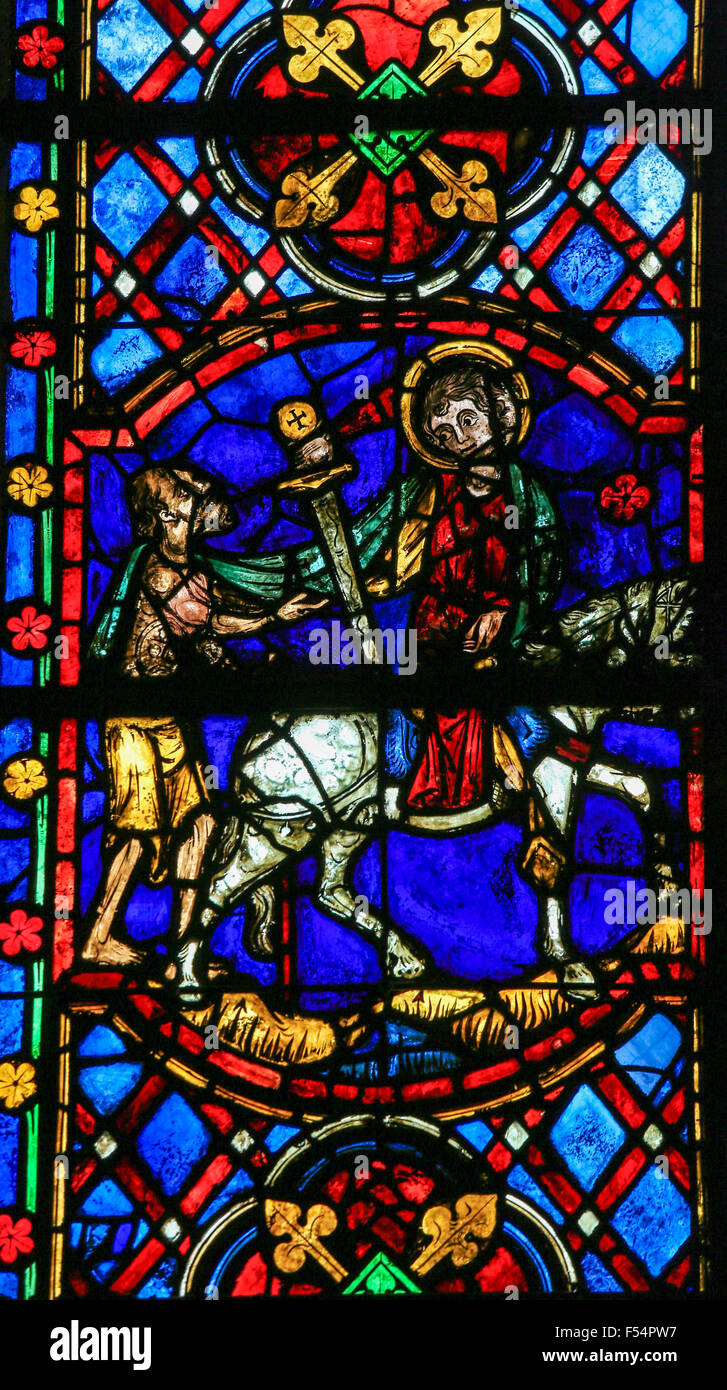 Stained glass window depicting Saint Martin of Tours cuting a piece of ...