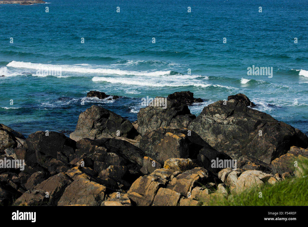The sea with waves and rocks off the coast of Cornwall at St Ives Stock ...