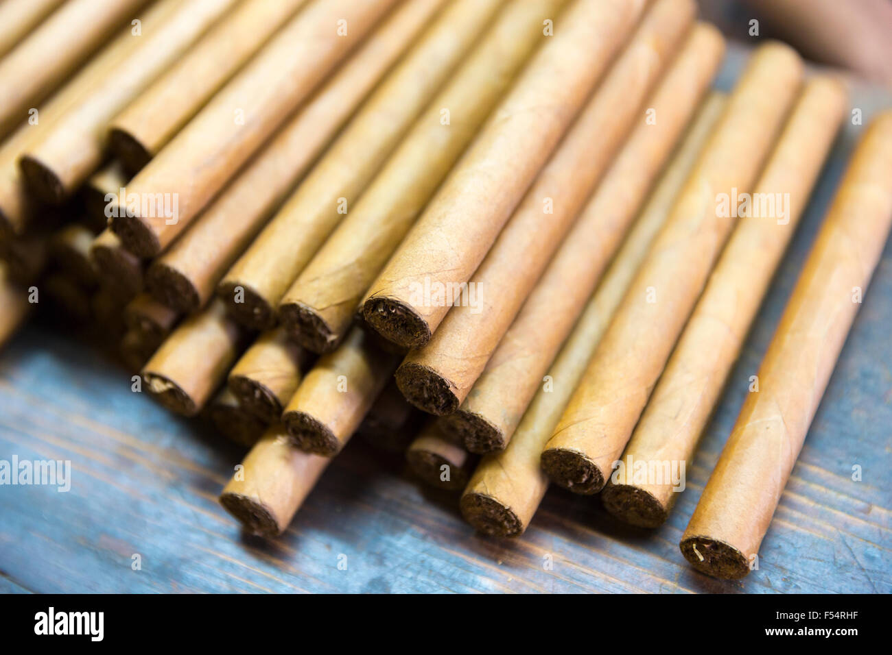 Stack of hand-rolled cigars of long leaf tobacco in traditional cigar ...