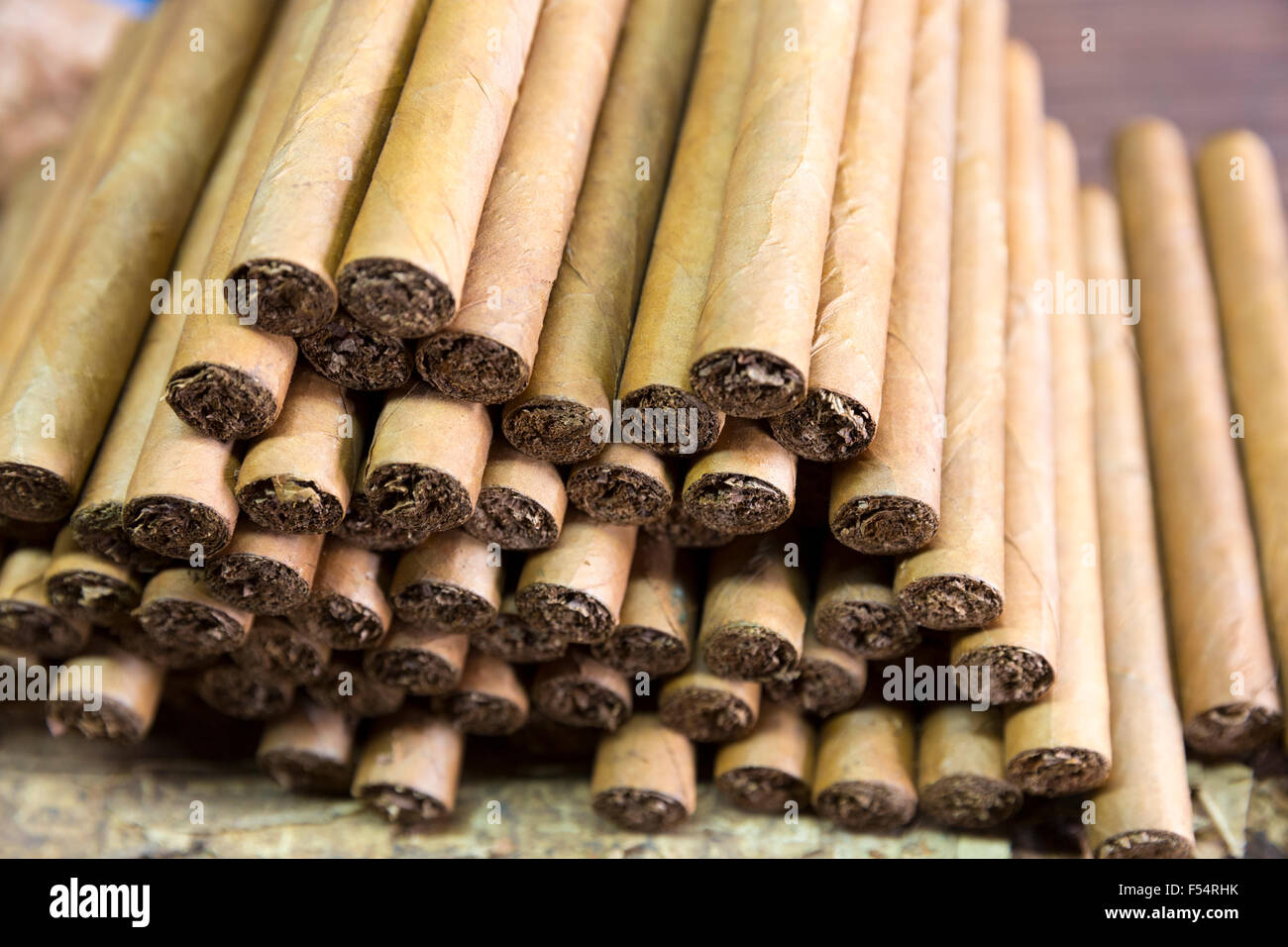 Stack of hand-rolled cigars of long leaf tobacco in traditional cigar ...