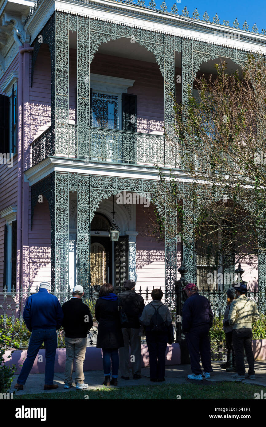 Tour group at grand mansion house, ornate wrought iron fretwork gallery ...