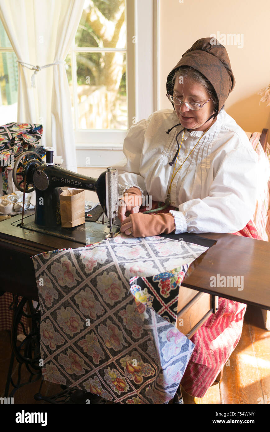 Craftsperson with sewing machine at Vermilionville history museum of ...