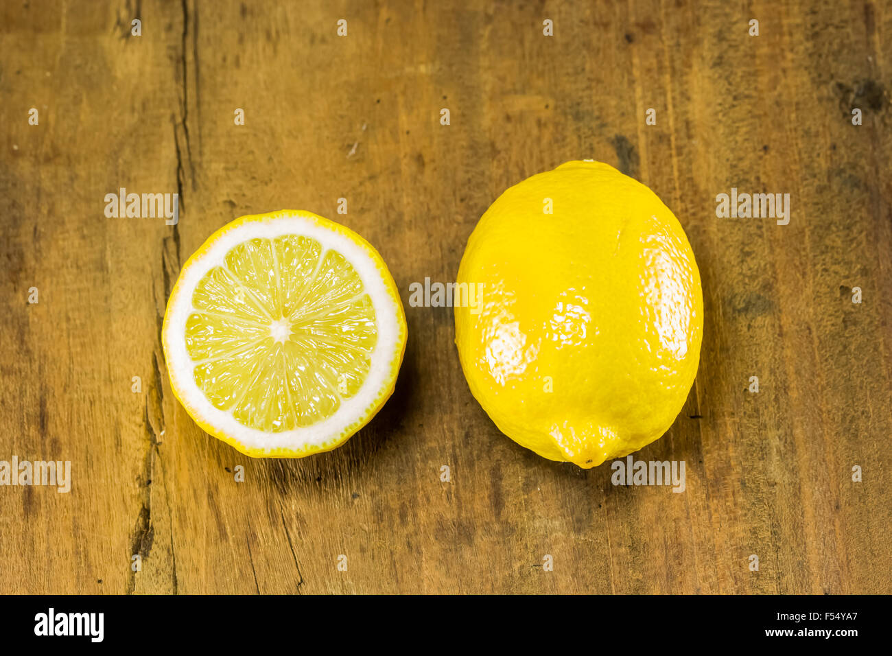 lemon and half on the wood background Stock Photo - Alamy