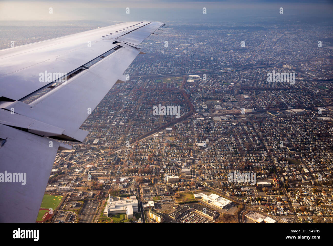 Aerial view from window of a jet airplane flying into New York, USA ...